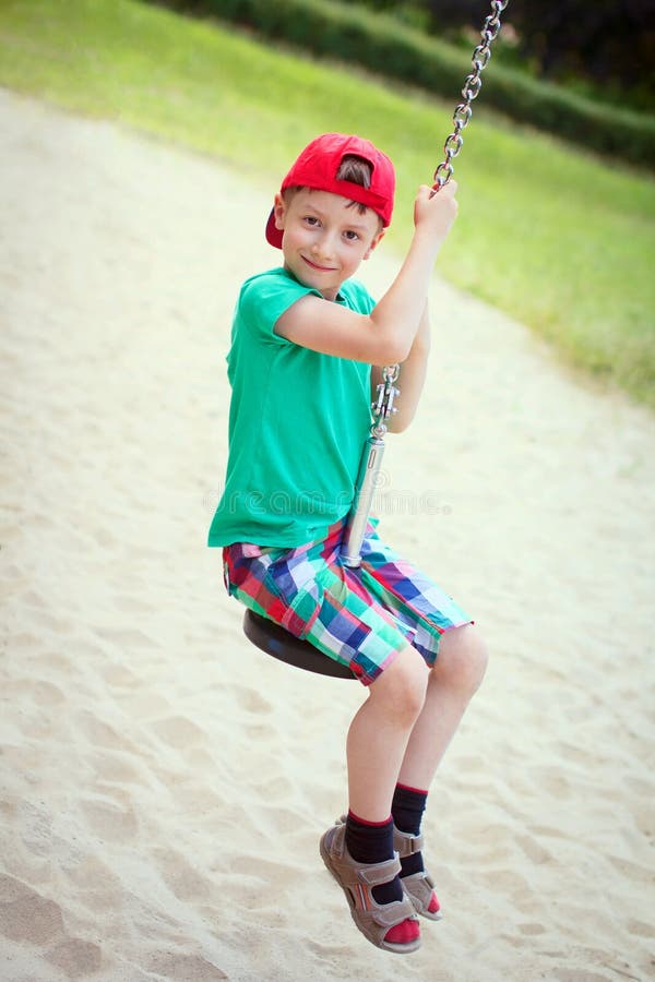 Little Boy in Red Cap Sit on Swing Rope Stock Photo - Image of park ...
