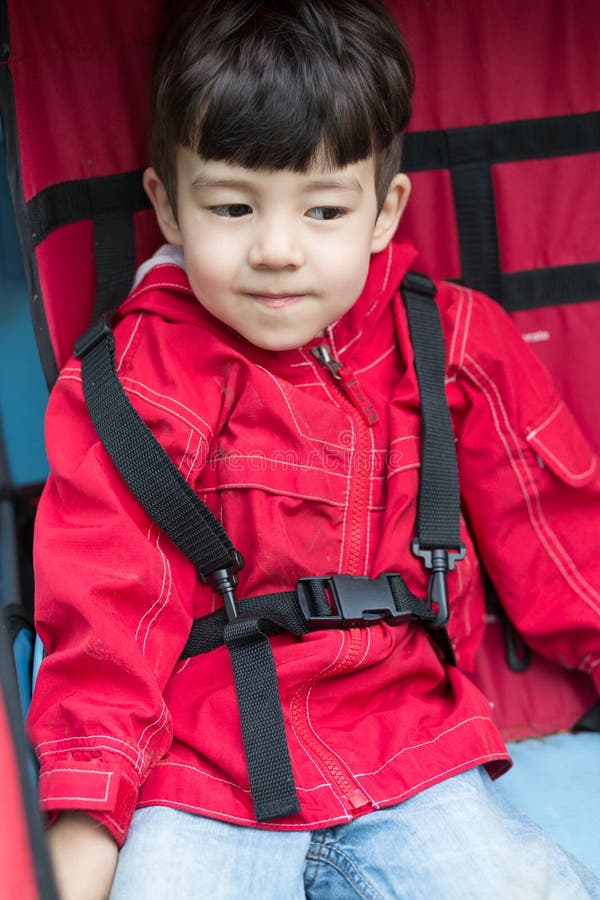 A Little Boy in a Red Jacket Wearing Stock Photo - Image of jeans ...