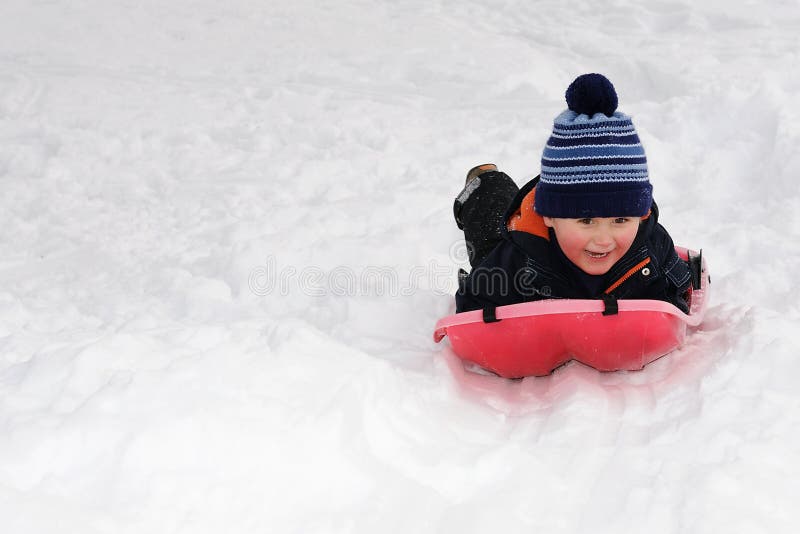 Little boy on red sled stock image. Image of lying, caucasian - 23211479