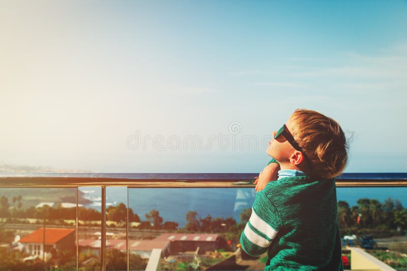 Little Boy Relaxed Looking at Sun on Balcony at Sea Stock Image - Image ...