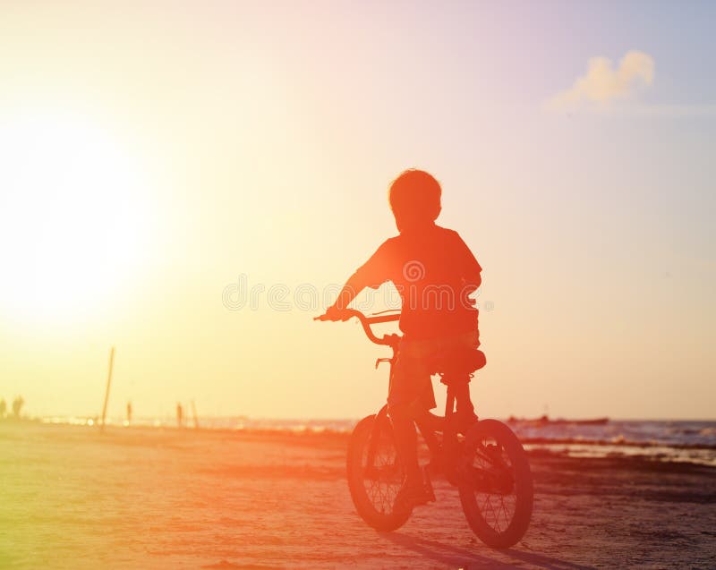 Little Boy Riding Bike at Sunset Stock Image - Image of person, cycling ...