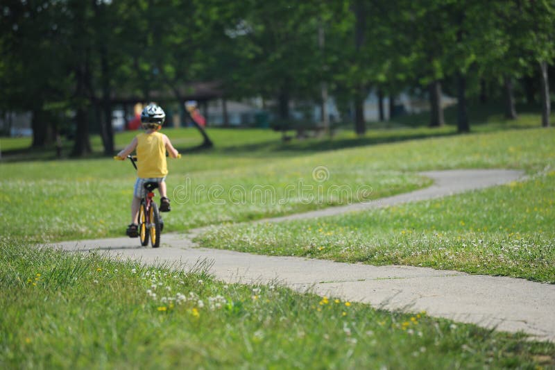 Little Boy Riding His Bicycle on a Twisting Narrow Road Stock Image ...