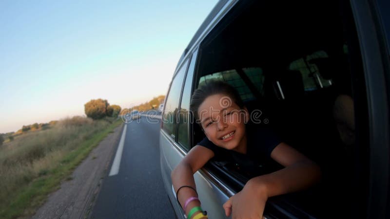 Boy is Riding in the Passenger Seat in the Car and Looking Happily at ...