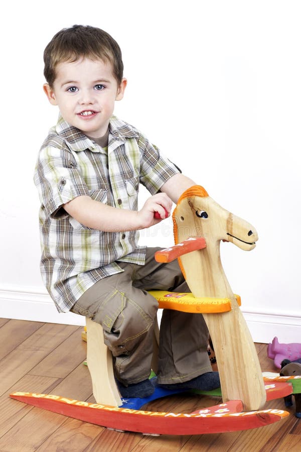 Little Boy Riding a Rocking Horse Stock Image - Image of colorful ...