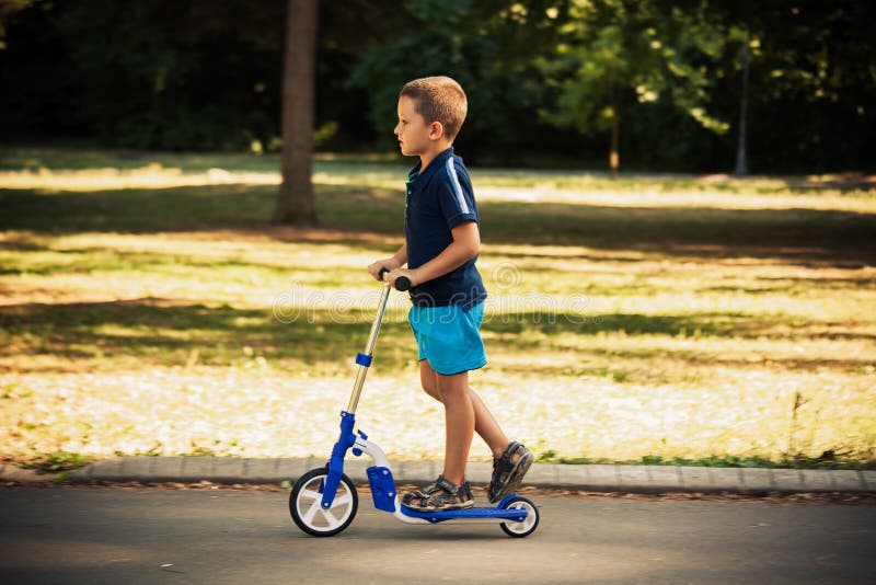 Little Boy Riding Scooter in Park Stock Image - Image of lifestyle ...