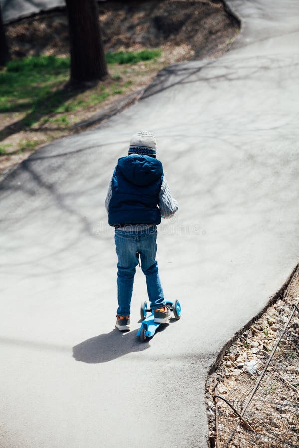 Beautiful Little Boy Riding a Scooter on the Street Stock Image - Image ...