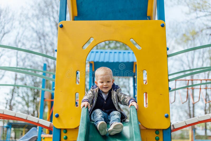 Little Boy Riding a Swing in Park Playground Stock Photo - Image of ...