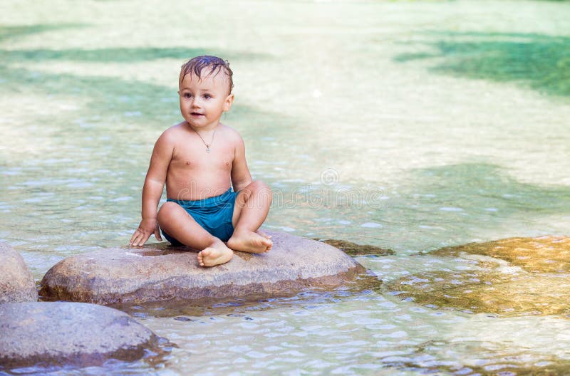 The little boy on the rock stock image. Image of vacation - 52400693