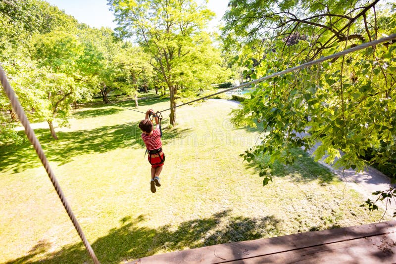 Little Boy at Rope Park Slide and Ride on Zip Line Stock Photo - Image ...