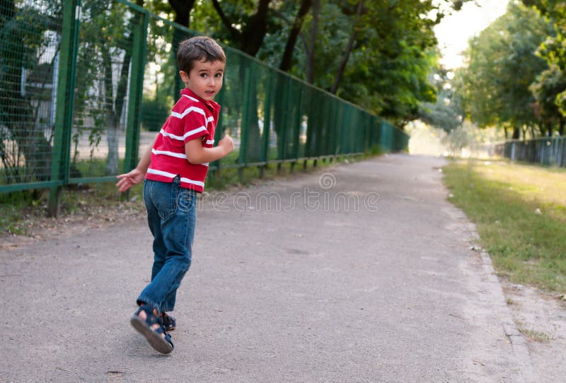 Little Boy Run by the Fence Stock Photo - Image of outdoors, caucasian ...