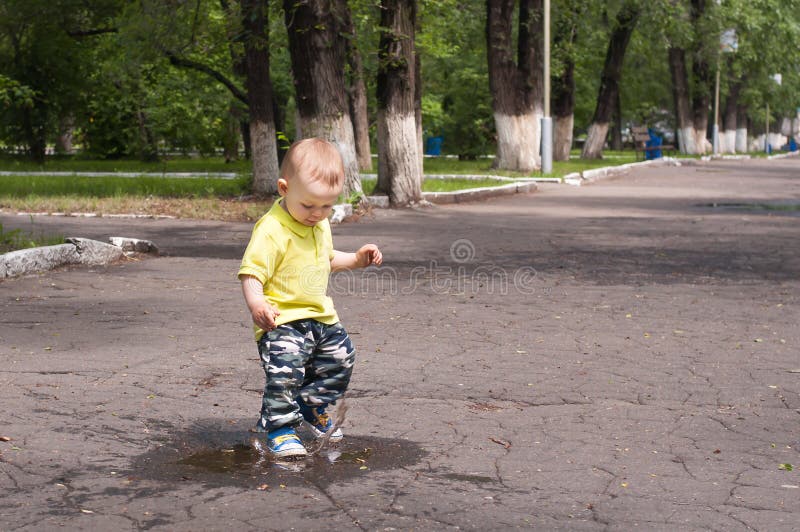Little Boy Running Around the Puddles Stock Image - Image of climate ...