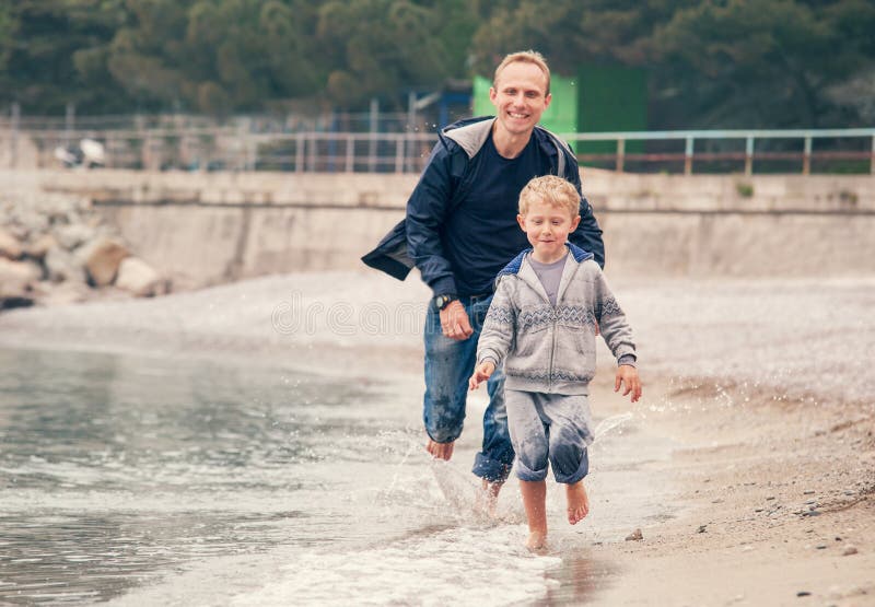 Little Boy Running with His Father at the Surf Line Stock Photo - Image ...