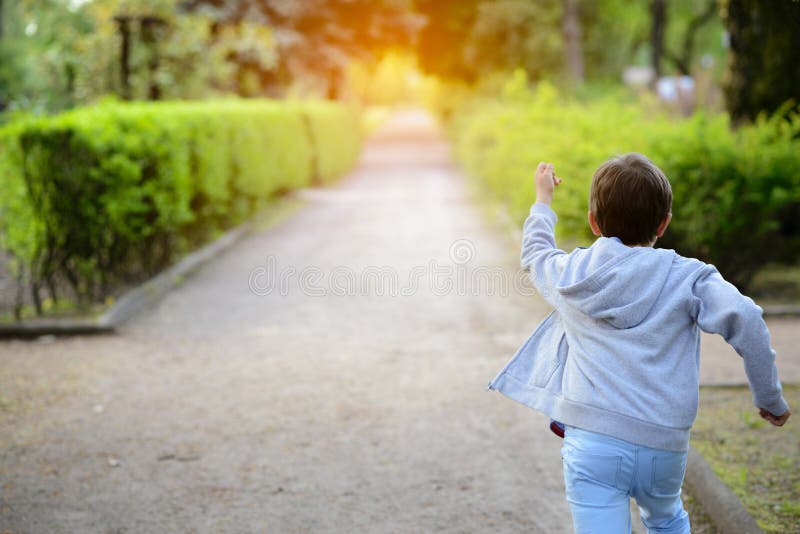 Little Boy Running in the Park. Back View Stock Photo - Image of ...