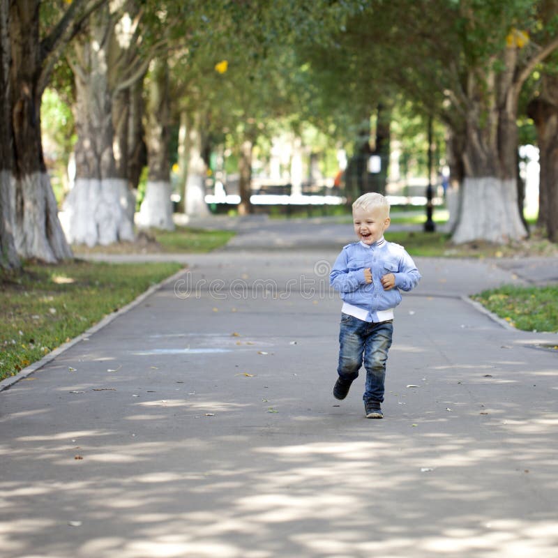 Little Boy Running on the Sidewalk in the Summer Park Stock Image ...