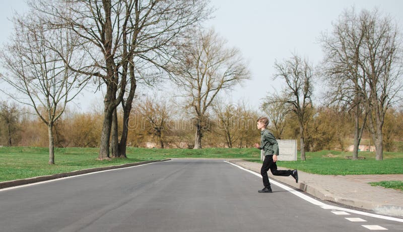A Little Boy Runs Across the Road Stock Image - Image of people, family ...