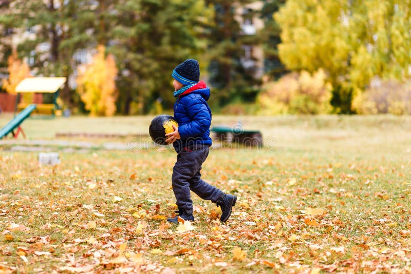Little Boy Runs Around with Ball in Fall Stock Image - Image of hand ...