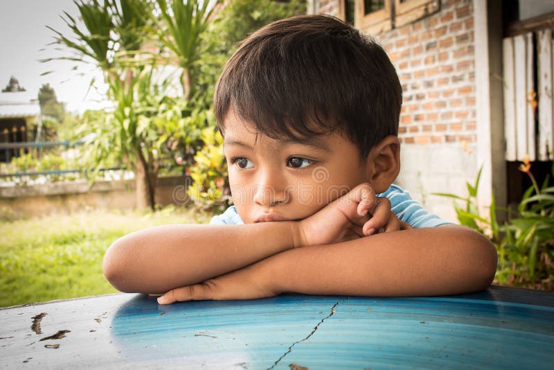 Little Boy Sad and Worried Lying on the Table Stock Photo - Image of ...