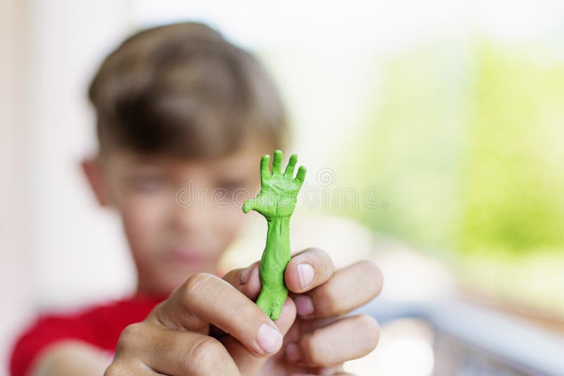 A Little Boy Shows a Craft Made of Plasticine Stock Image - Image of ...