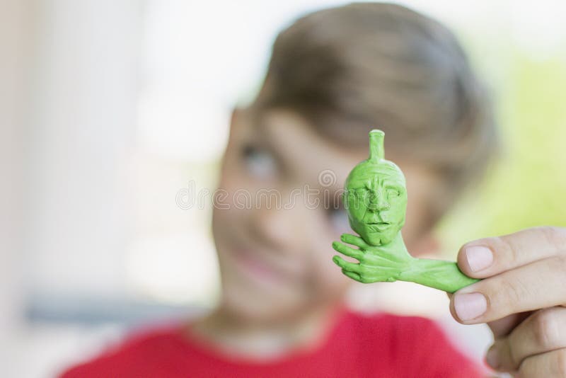 A Little Boy Shows a Craft Made of Plasticine Stock Image - Image of ...