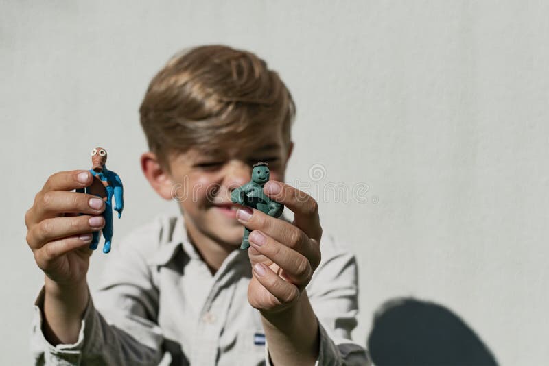 A Little Boy Shows His Plasticine Crafts Stock Photo - Image of ...