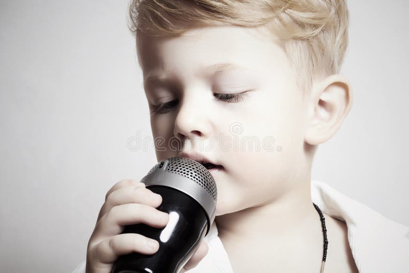 Smiling Boy Holding a Microphone Stand Stock Photo - Image of person ...