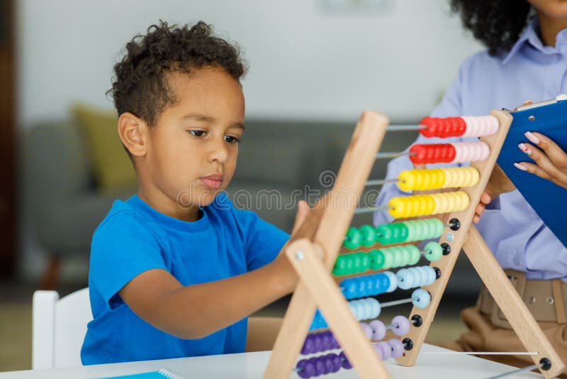 A Little Boy Sits at a Desk and Does His Homework, Little Boy Doing ...