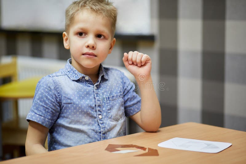 Little Boy Sits at Desk with Paper Stock Photo - Image of kindergarten ...