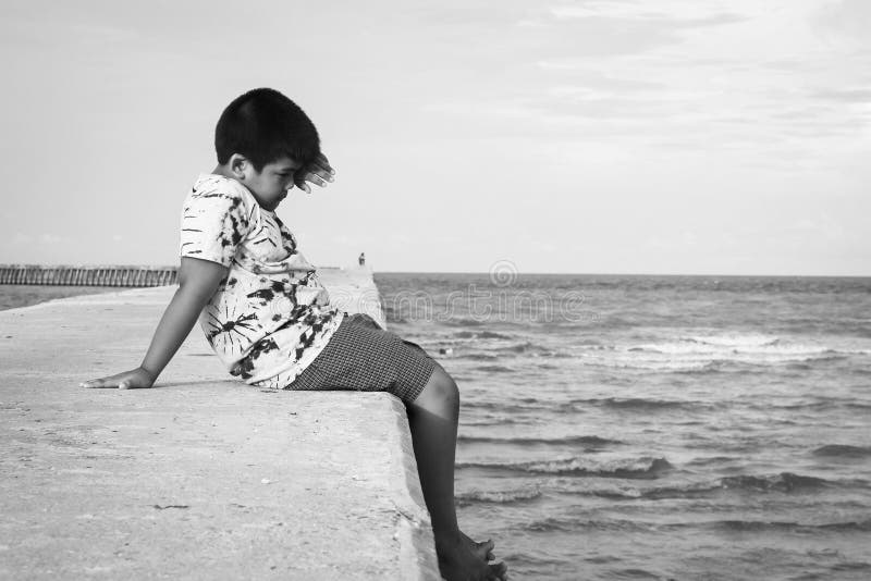 Little Boy Sitting Alone on Walkway at Sea Stock Photo - Image of alone ...