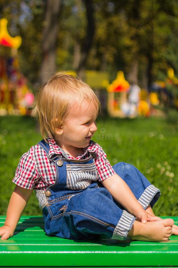 Little Boy Sitting on a Bench Stock Image - Image of bench, sitting ...