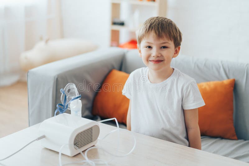 Little Boy Sitting on the Couch in Front of the Nebulizer Stock Photo ...