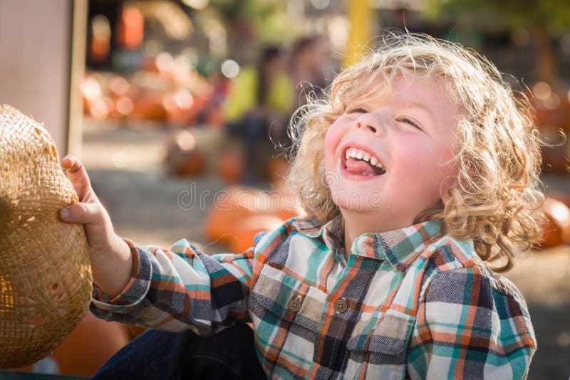 Little Boy Sitting with a Cowboy Hat in a Rustic Ranch Setting at the ...