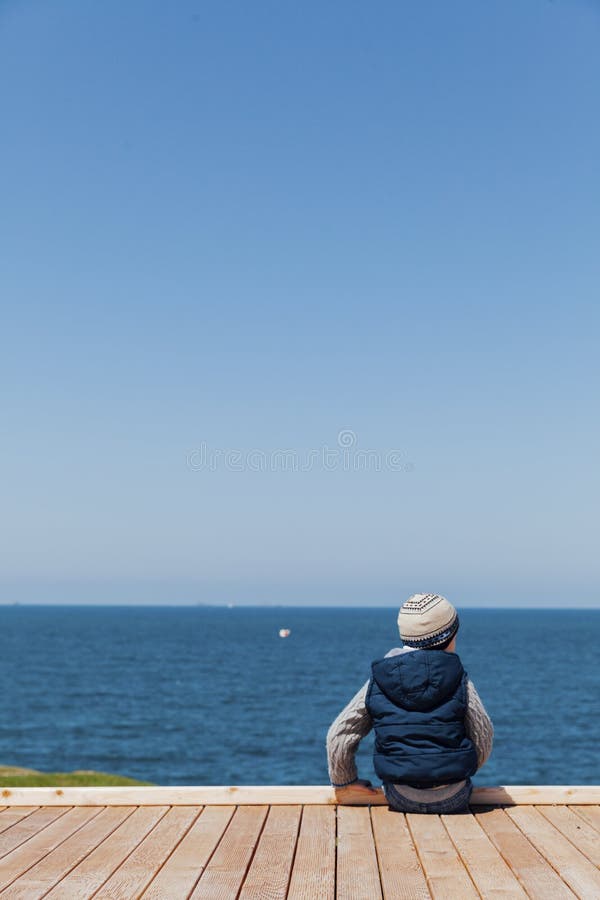 Little Boy Sitting Looking at the Sea Stock Photo - Image of person ...