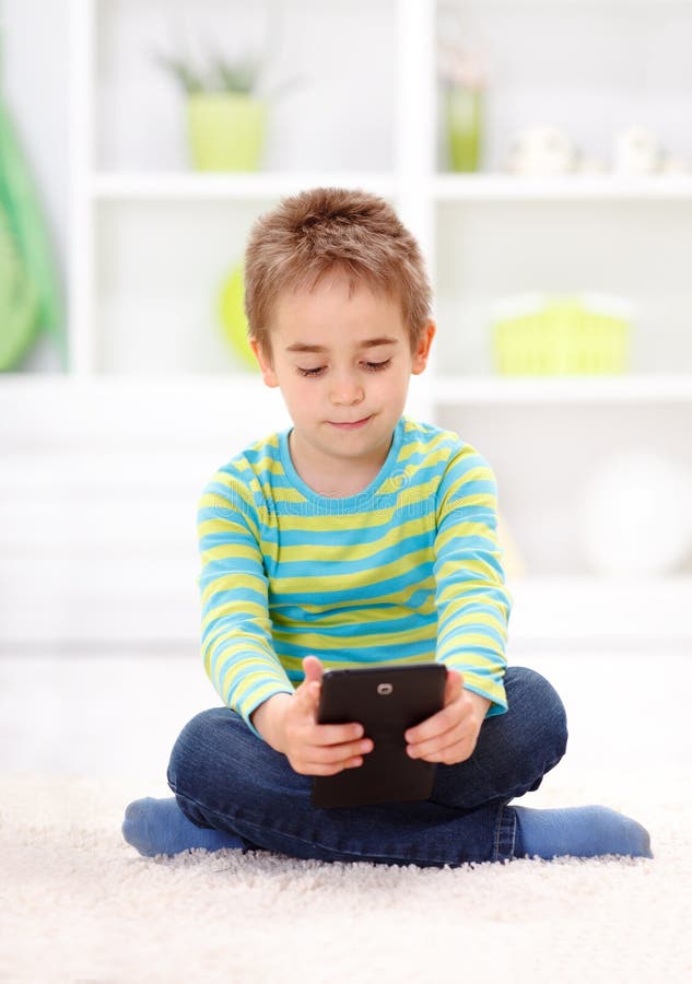 Little Boy Sitting and Reading from Tablet Stock Photo - Image of ...