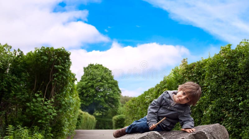 A Little Boy Sitting on a Rock. Stock Photo - Image of young, sunny ...