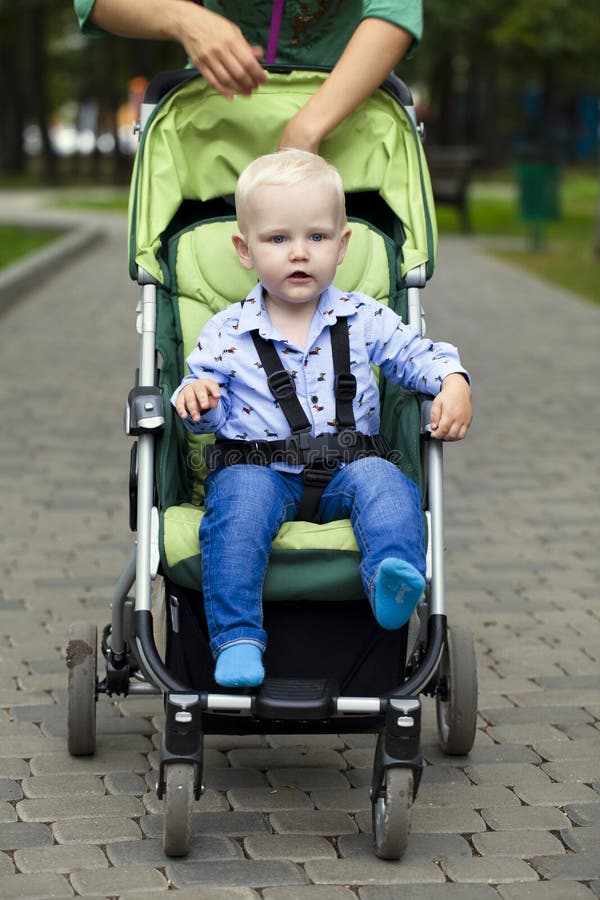 Little Boy Sitting in Stroller Stock Photo - Image of activity, opening ...