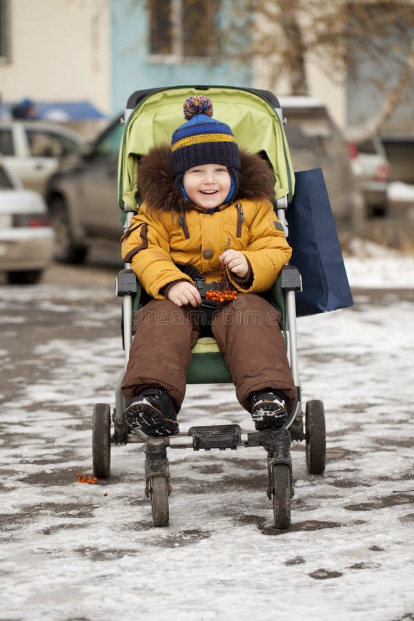 Little Boy Sitting in Stroller Stock Image - Image of cheek, overalls ...
