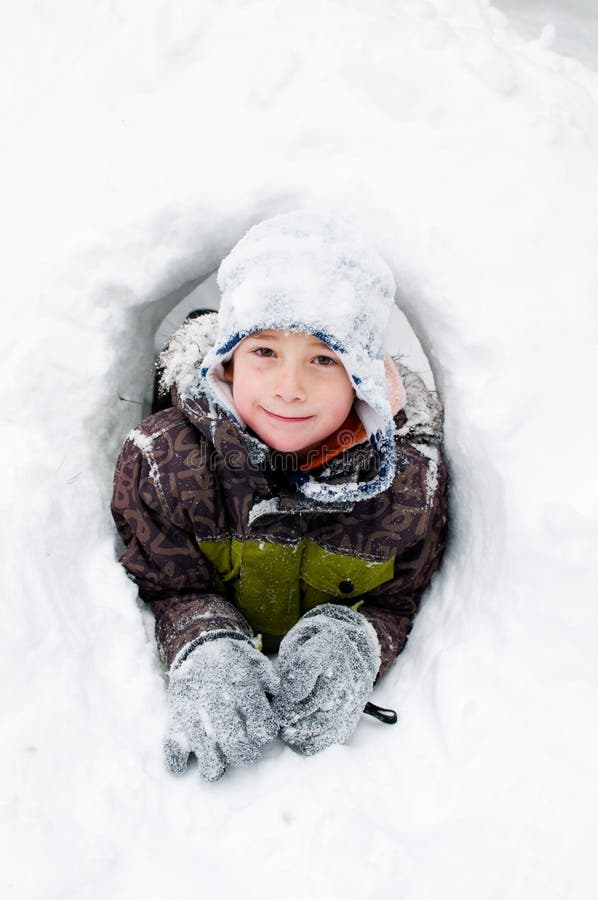 Little boy in a snow fort stock image. Image of childhood - 18379381