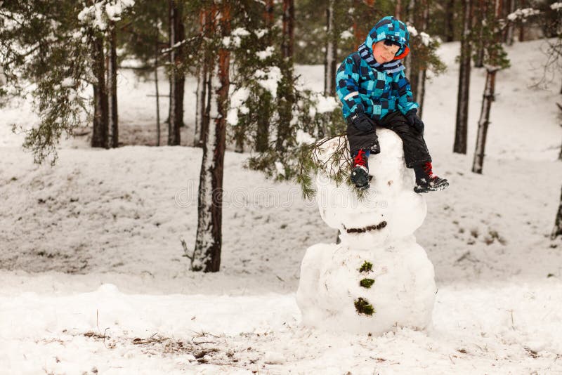 Little boy and snowman stock image. Image of forest, boots - 35897751