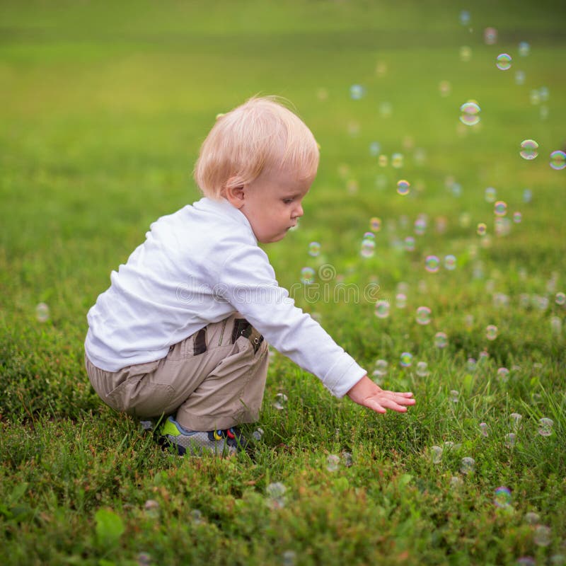 Little Boy and Soap Bubbles Stock Image - Image of grass, baby: 34152237