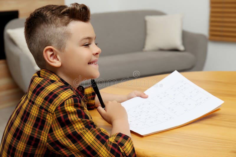 Little Boy Solving Sudoku Puzzle at Table Stock Image - Image of ...