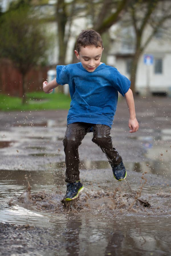 Little Boy Splashing in a Mud Puddle, Stock Photo - Image of outdoors ...