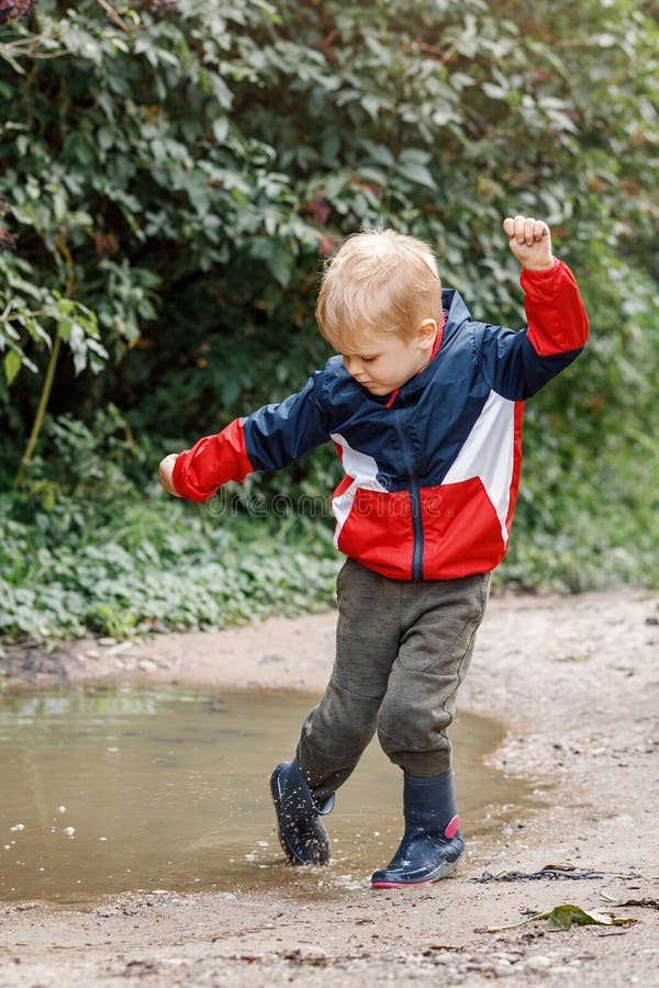 Young Children Playing in a Muddy Puddle Stock Photo - Image of little ...