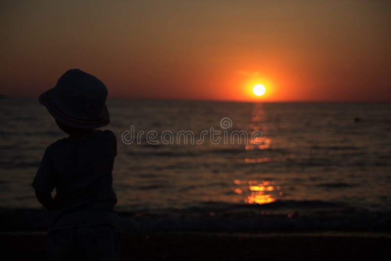 Little Boy Standing Back and Watching the Sunset Stock Photo - Image of ...