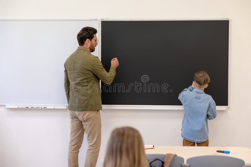 Little Boy Standing in Classroom while Learning Math Lesson with His Teacher. Stock Photo ...