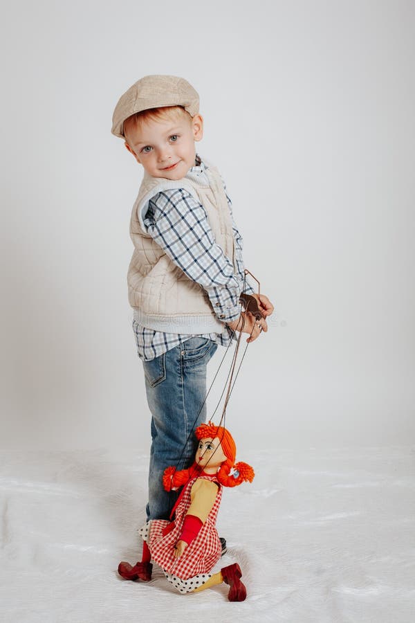 Little Boy in Cap Standing with a Puppet Doll Stock Photo - Image of ...