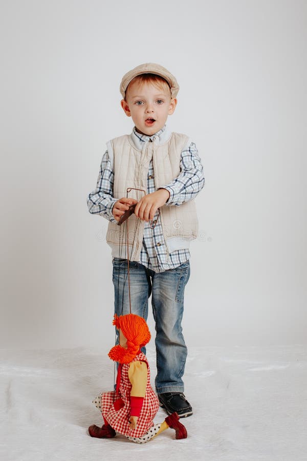 Little Boy in Cap Standing with a Puppet Doll Stock Photo - Image of ...
