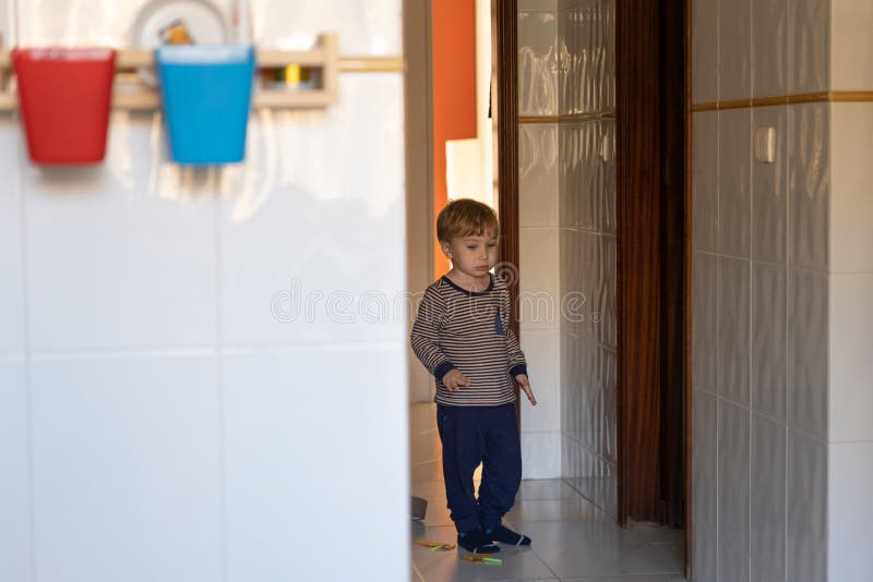 A Little Boy Stands in the Corridor in the Apartment Stock Photo ...