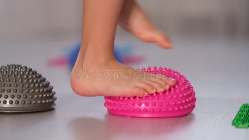 Little Boy Steps on Orthopedic Massage Mats with Different Stiffness ...