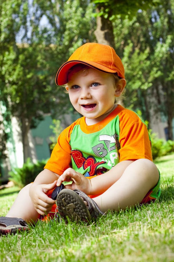 Little Boy is in Summer on a Lawn Stock Photo - Image of flower, face ...