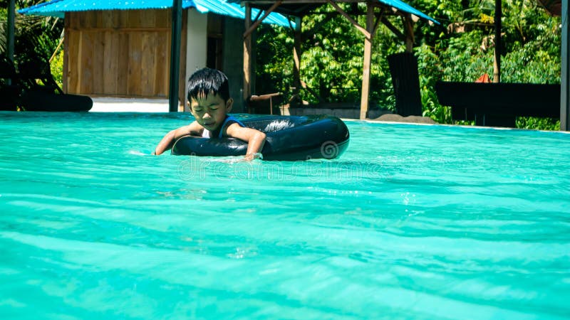 A Little Boy is Swimming in the Pool Stock Image - Image of happy, pool ...